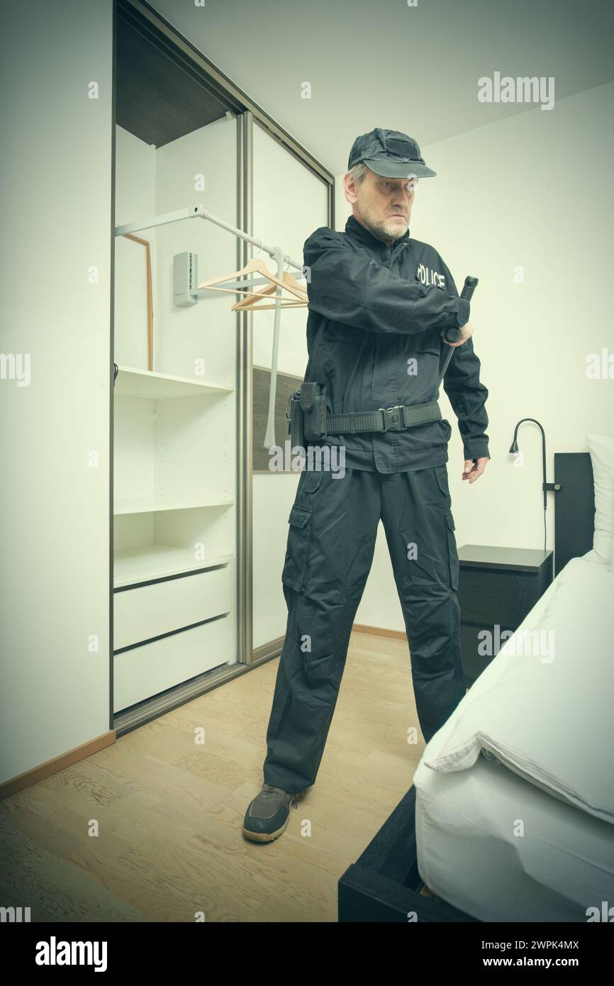 Older slim city police officer dressing up in bedroom for service Stock ...