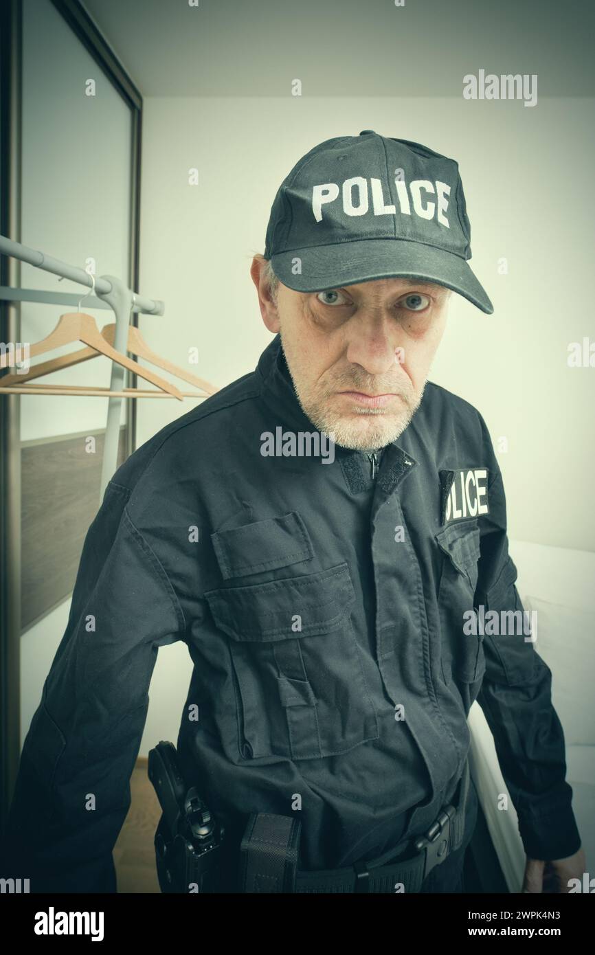 Older slim city police officer dressing up in bedroom for service Stock ...
