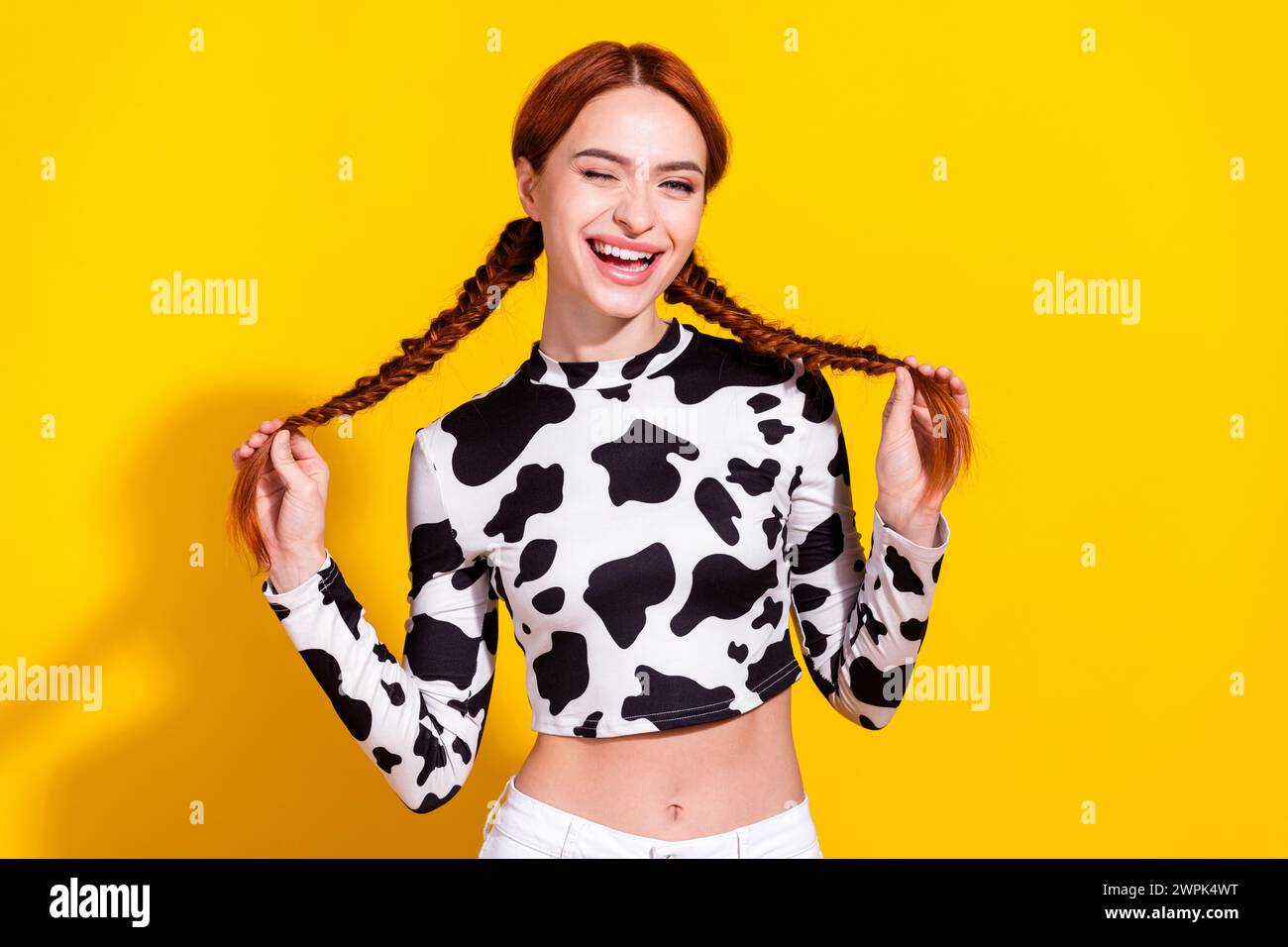 Photo of flirty sweet woman wear cow skin top winking you holding ...