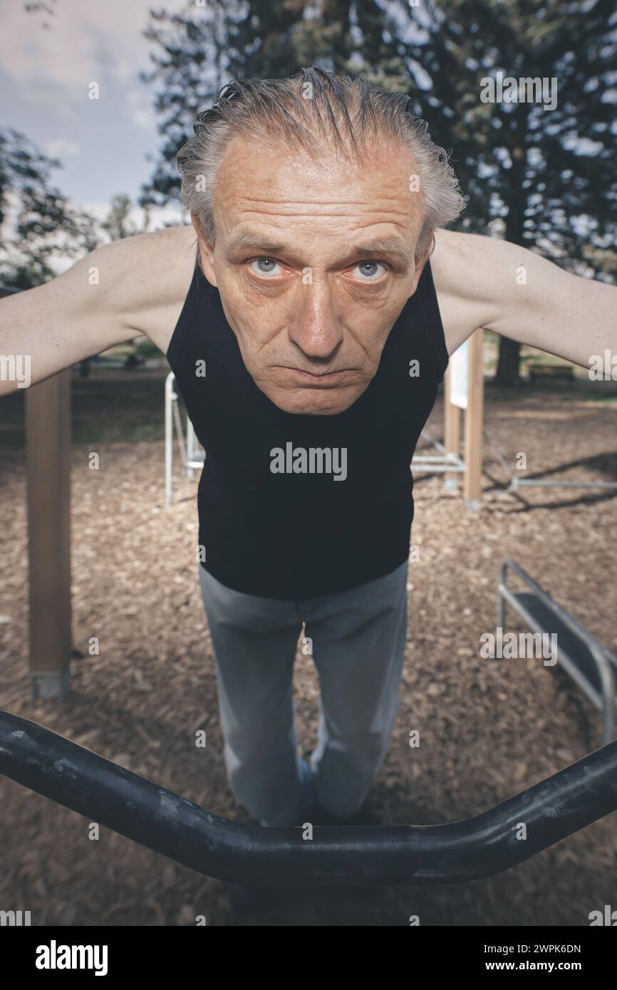 Ugly man of bad condition trying workout in outdoor gym Stock Photo - Alamy