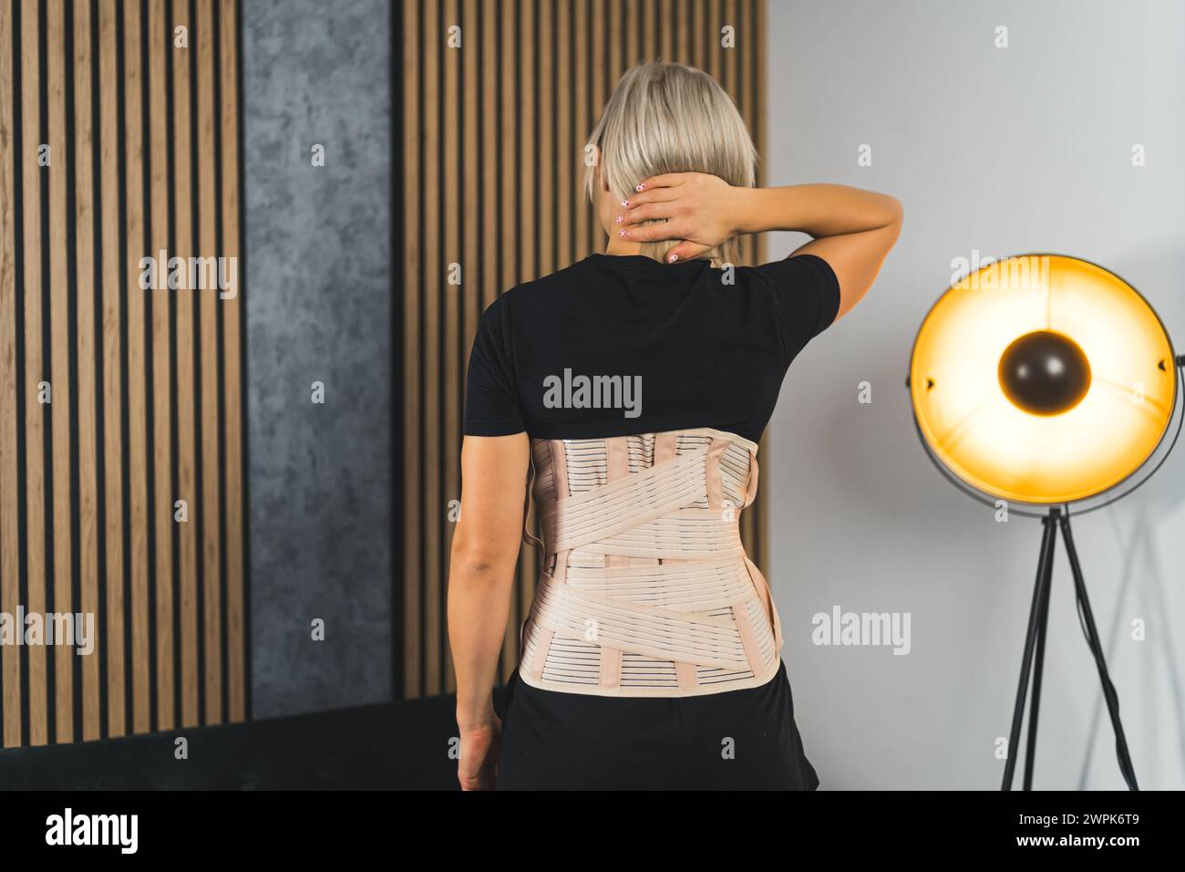 lady patient wearing back pain support belt for orthopedic lumbar ...
