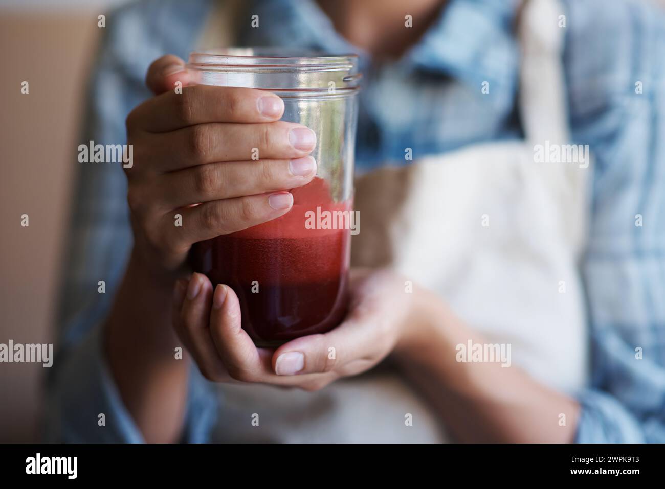 Hands, glass and juice with kitchen, closeup and person with smoothie ...