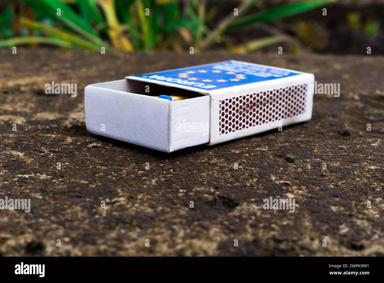 Matchbox thrown on wet sand, safety matches. Environmental ...