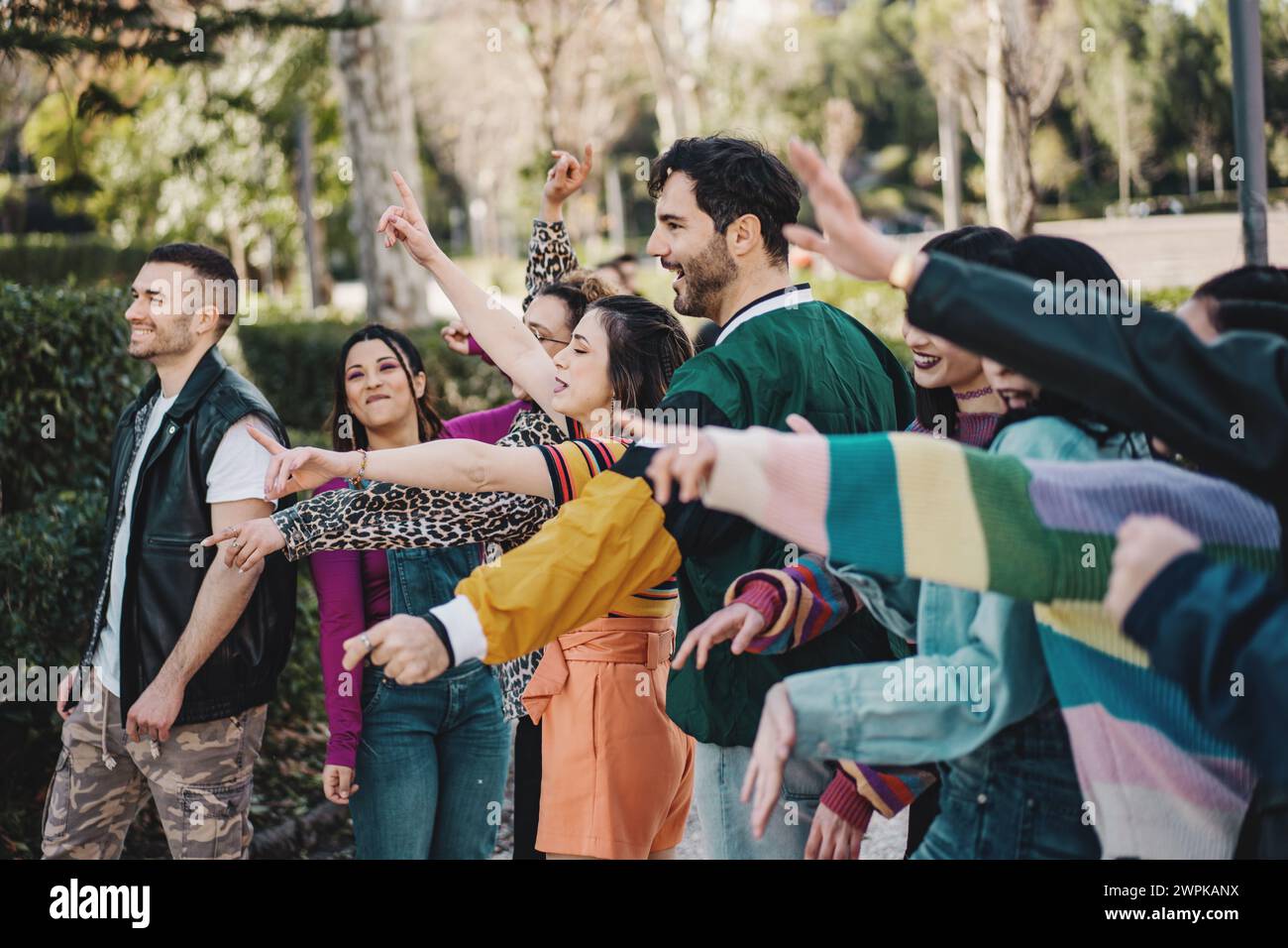 Diverse friends dancing and having fun in a park setting - Joyful ...