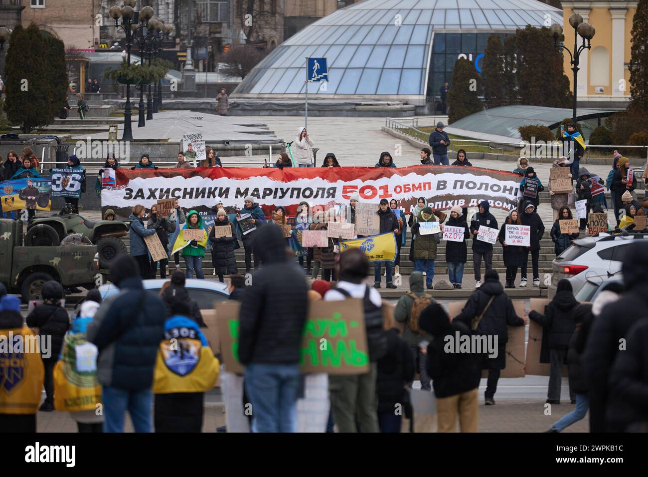 Large group of Ukrainian activists hold a banner "Defenders of Mariupol ...