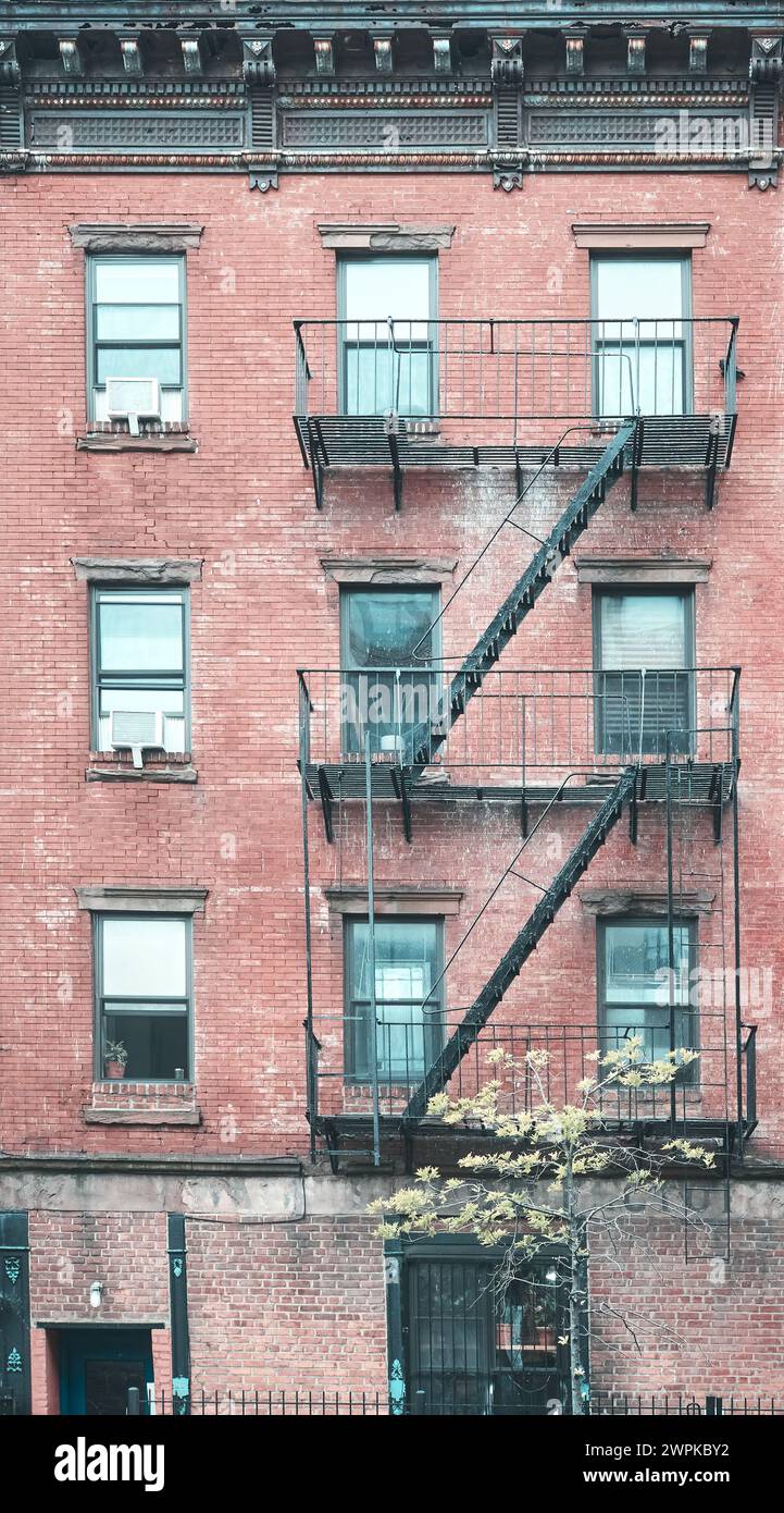 Old red brick building with fire escapes, color toning applied, New ...