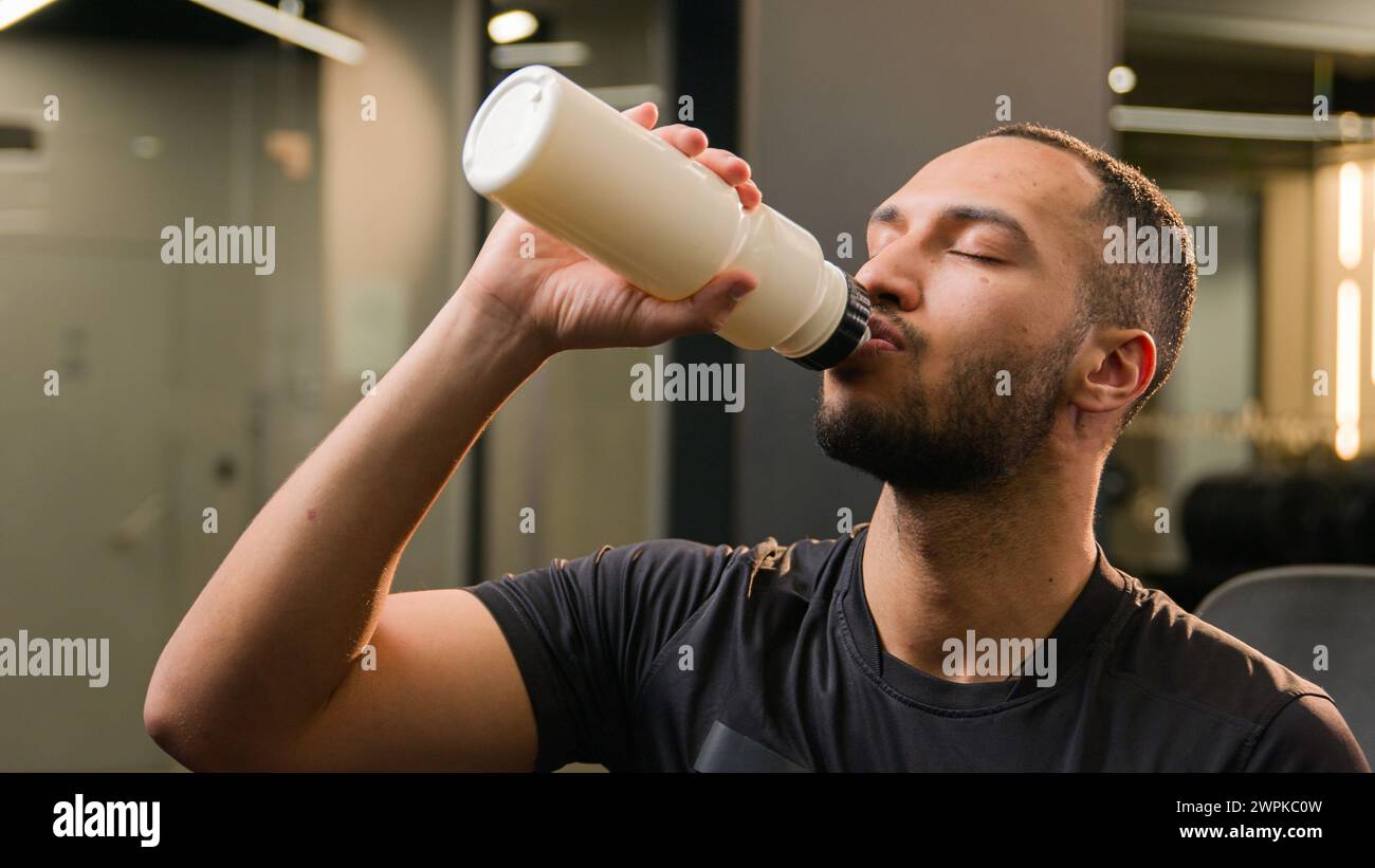 American multiethnic guy sportsman drink refresh after workout sport ...