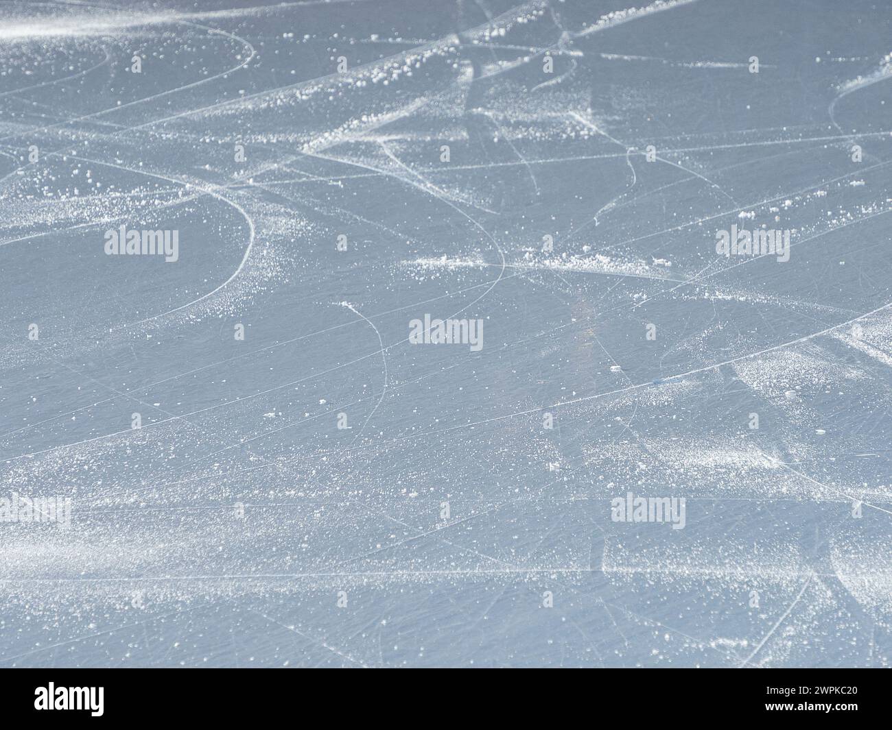 Ice texture on a skating rink, tracks on the ice from skates, frozen ...