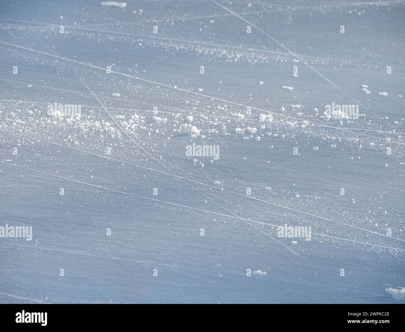 Ice texture on a skating rink, tracks on the ice from skates, frozen ...