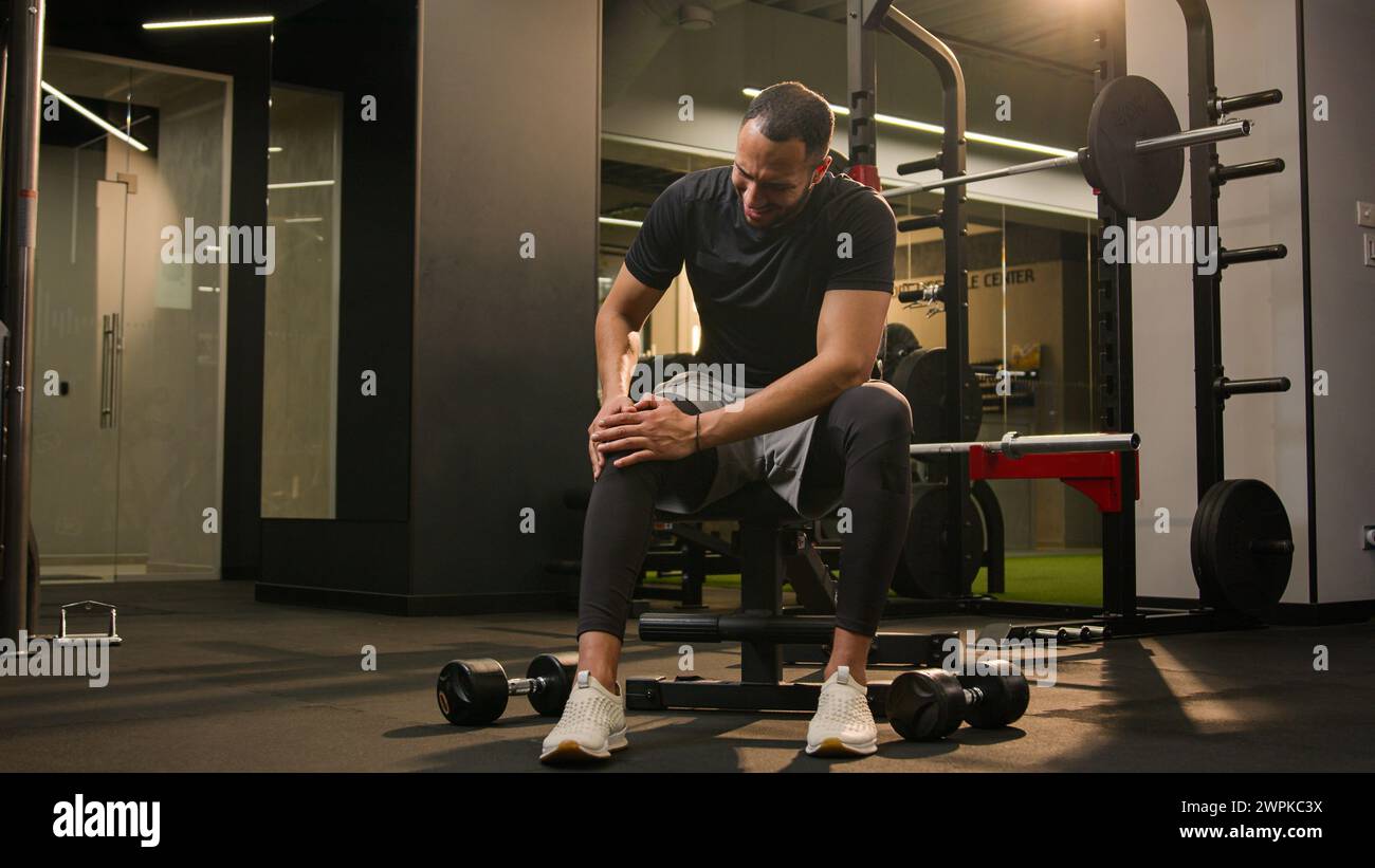 Latino American man feel bad ache knee pain painful cramp injury leg ...