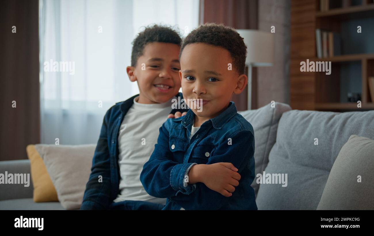 Two funny African American children siblings after quarrel at home ...