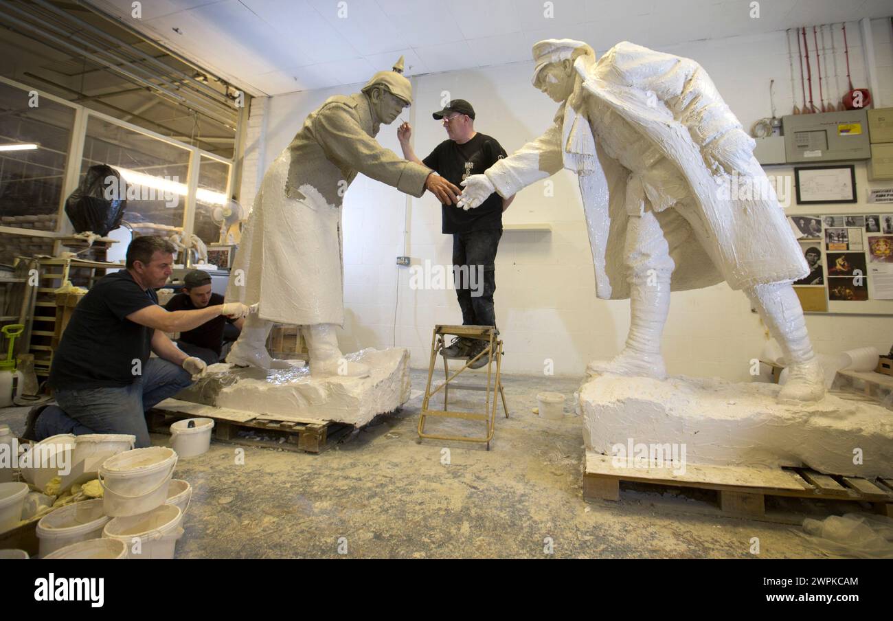 13/11/14 Sculptor, Andrew Edwards (centre) makes the finishing touches ...