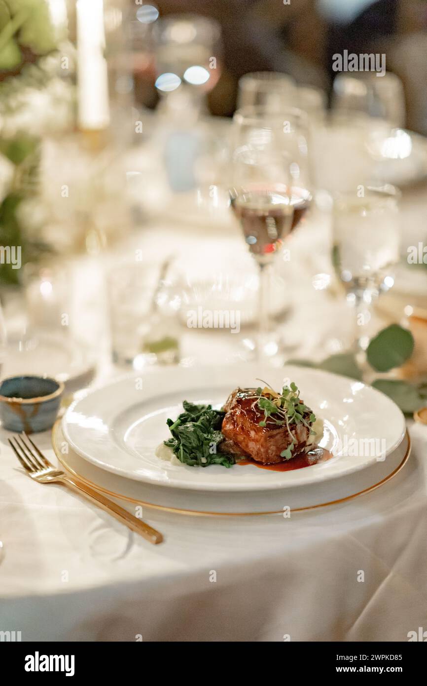 dinner table set with plated meal Stock Photo - Alamy