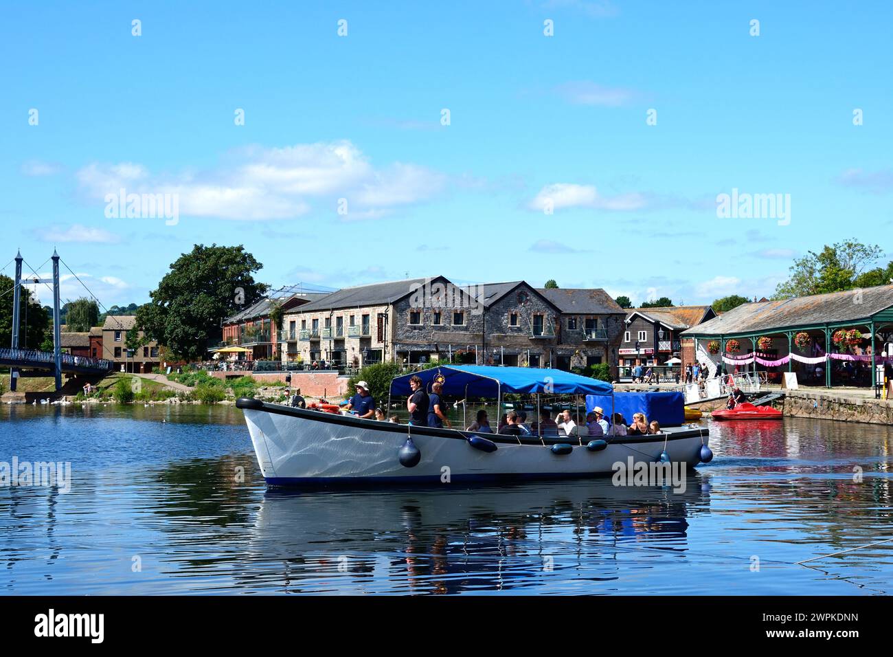 Passengers aboard a tour boat along the River Exe with the East Bank ...