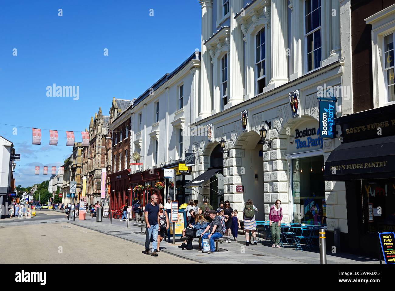 Shops and shoppers along Queen Street in the city centre, Exeter, Devon ...