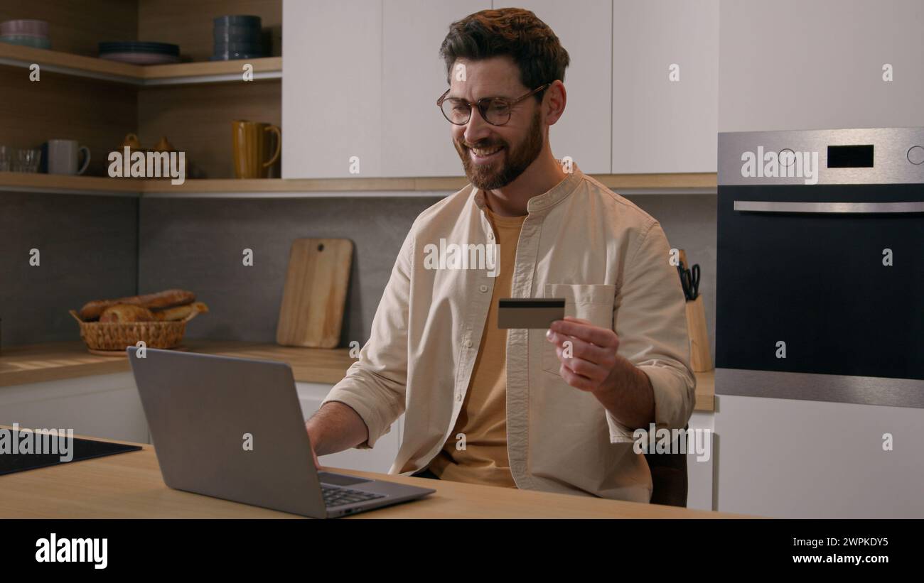 Caucasian buyer man male using laptop and credit bank card buying ...