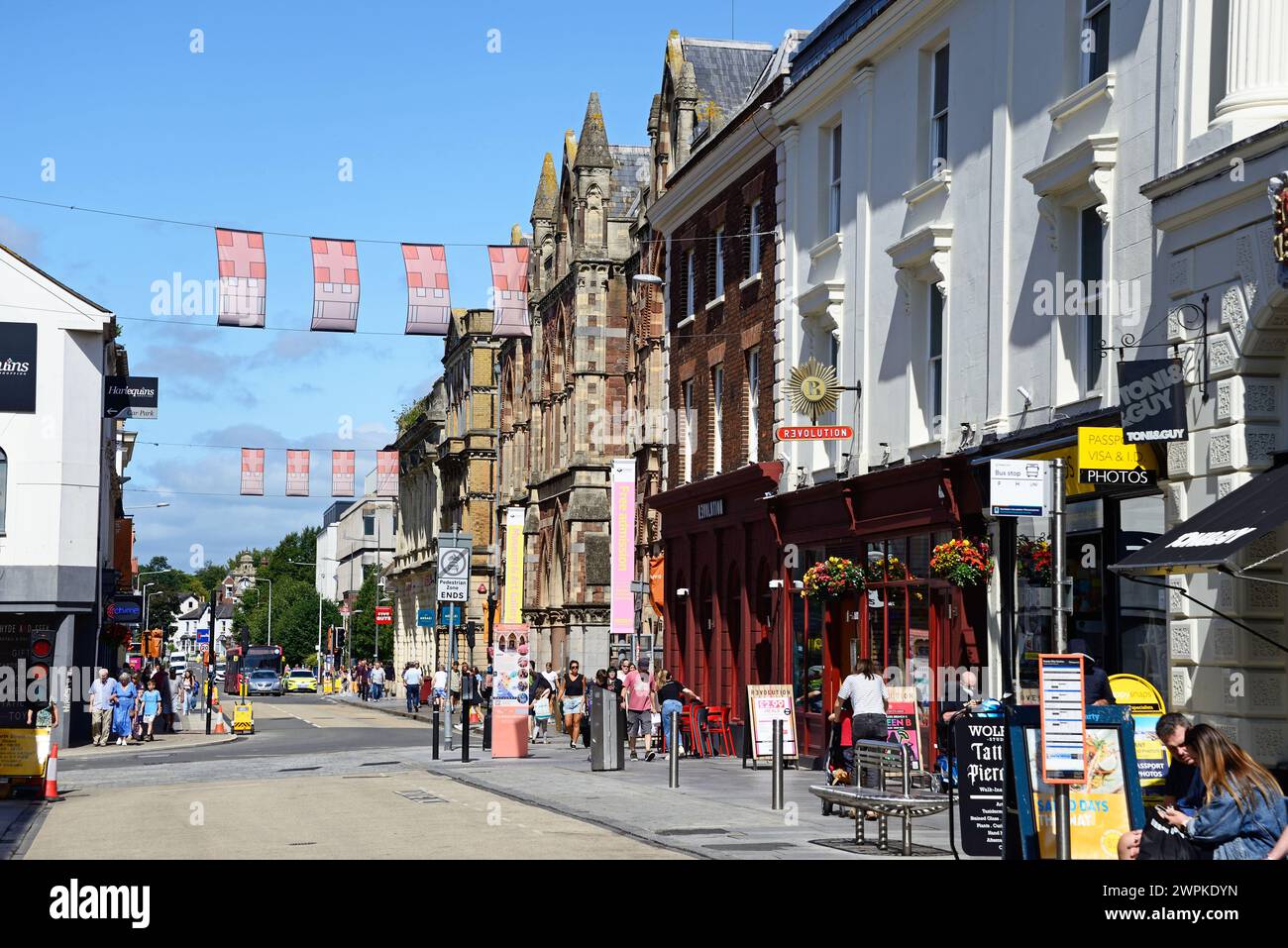 Shops and shoppers along Queen Street in the city centre, Exeter, Devon ...