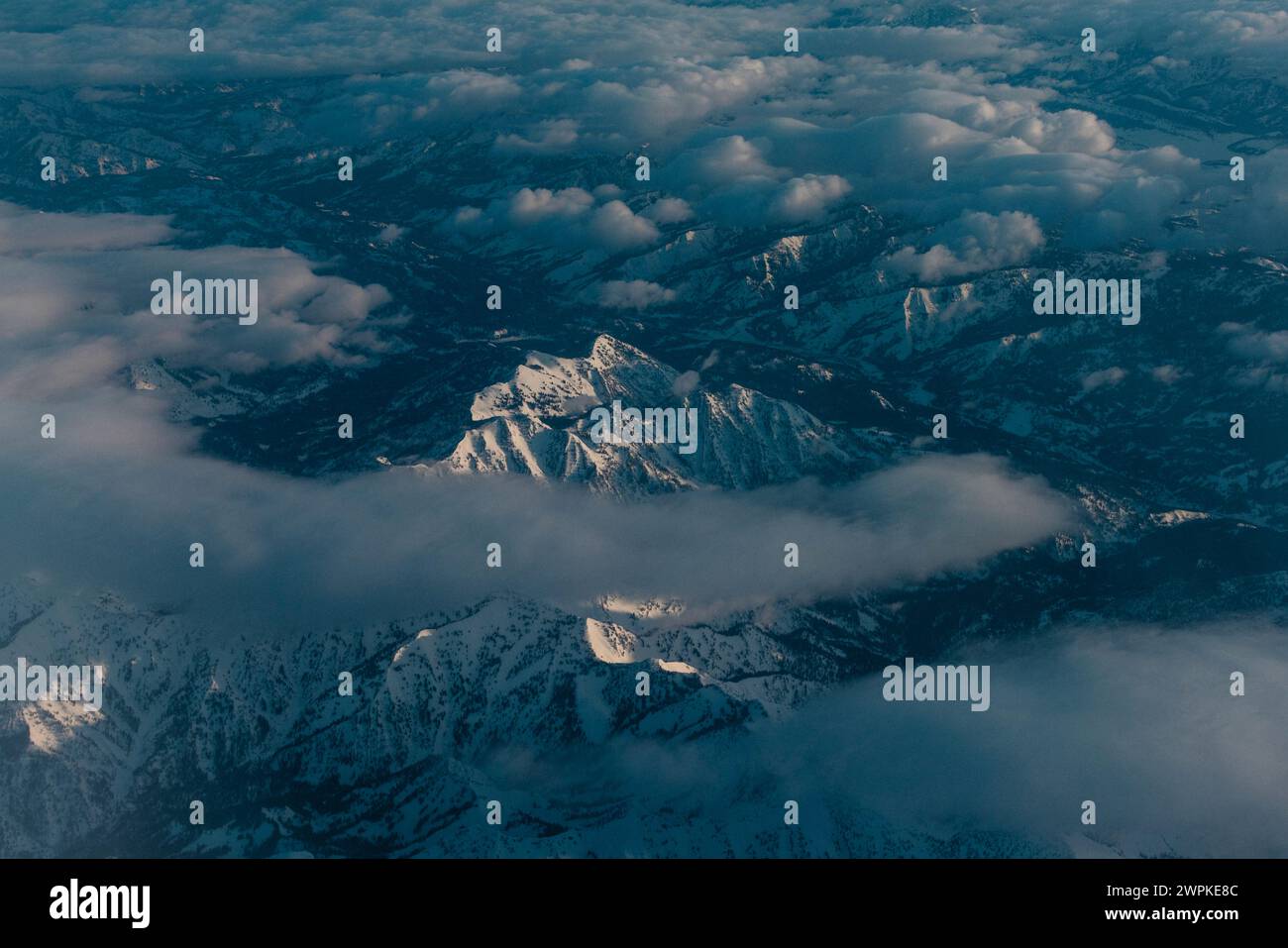 Flying over snow capped mountains in Colorado in morning light Stock ...
