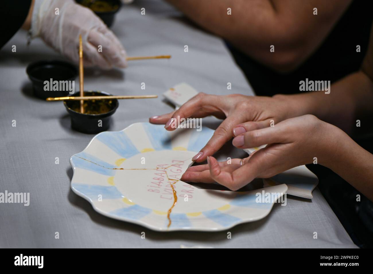 Non Exclusive: LVIV, UKRAINE - MARCH 7, 2024 - A woman repairs a broken plate during a kintsugi ...