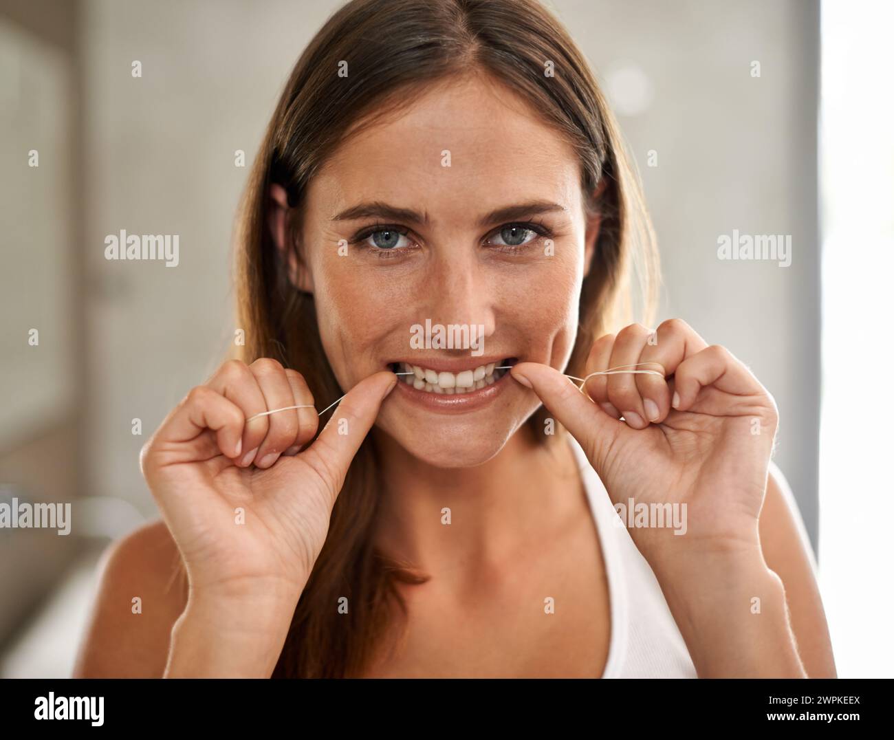 Bathroom, portrait and woman flossing teeth for dental health, care and ...