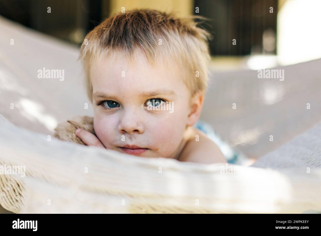 A young boy lays in a hammock while on vacation Stock Photo - Alamy
