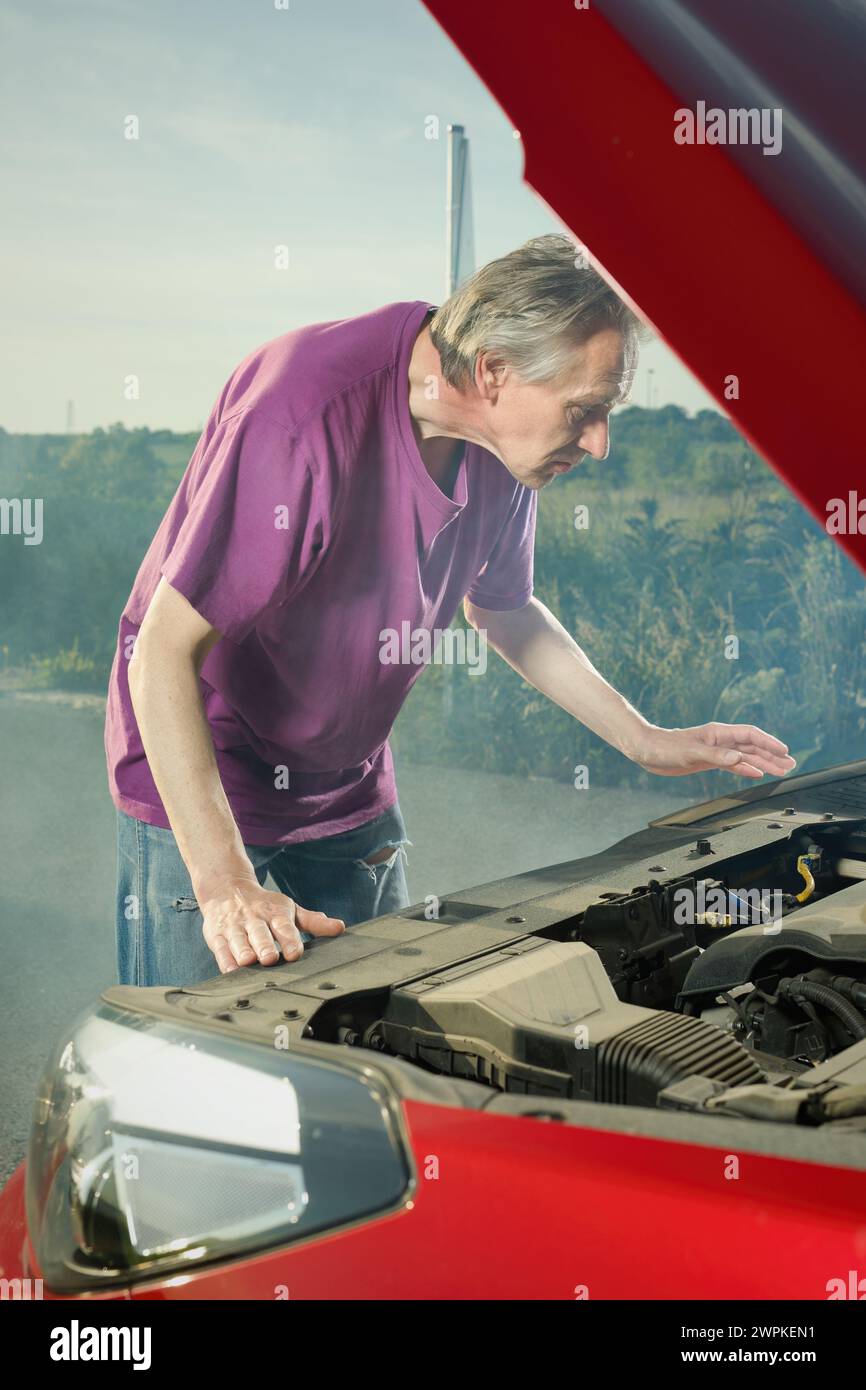 Pensioner checking state of his car with smoking engine Stock Photo - Alamy
