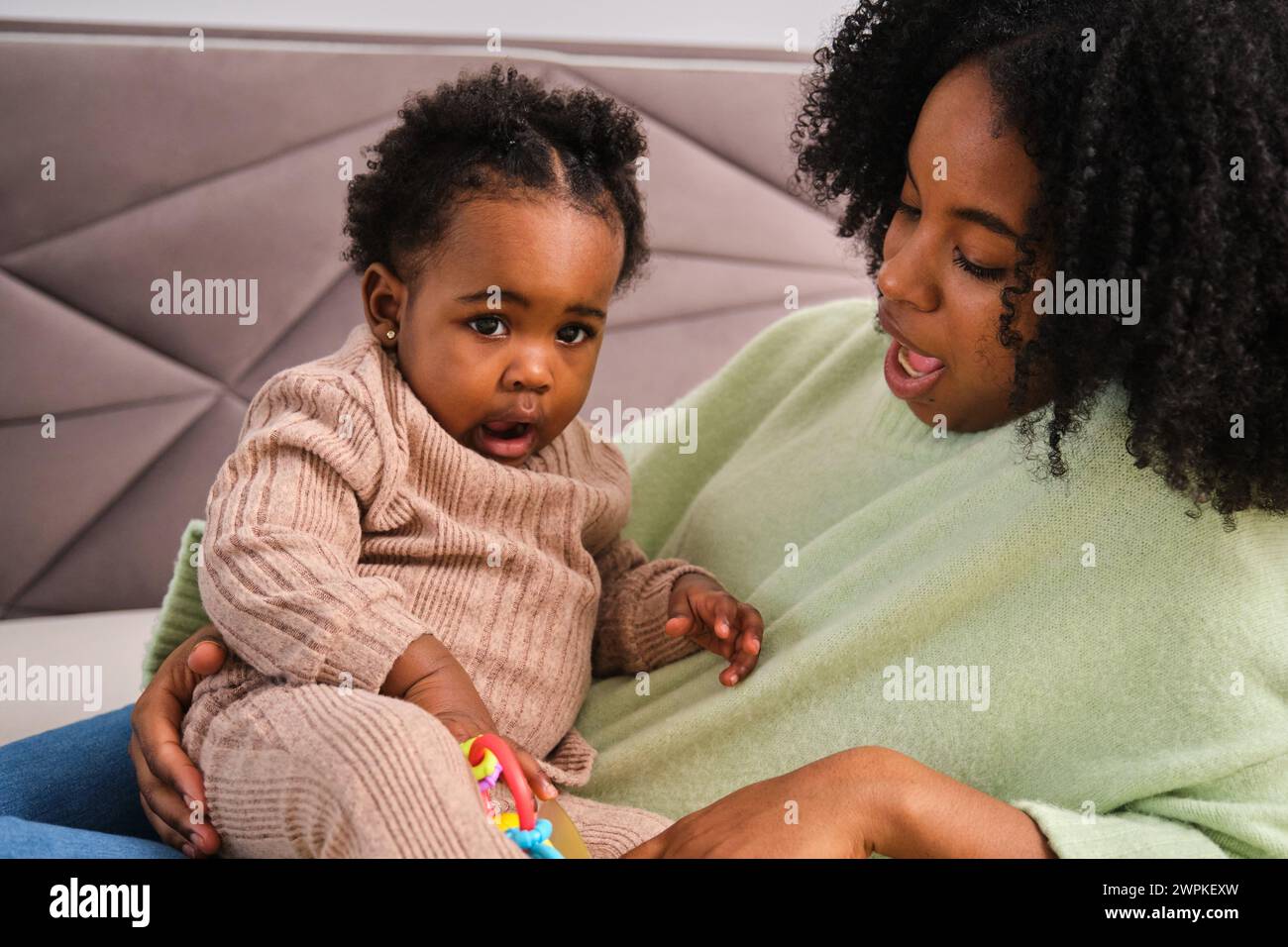 Cuban mother and daughter making a funny face at home Stock Photo - Alamy