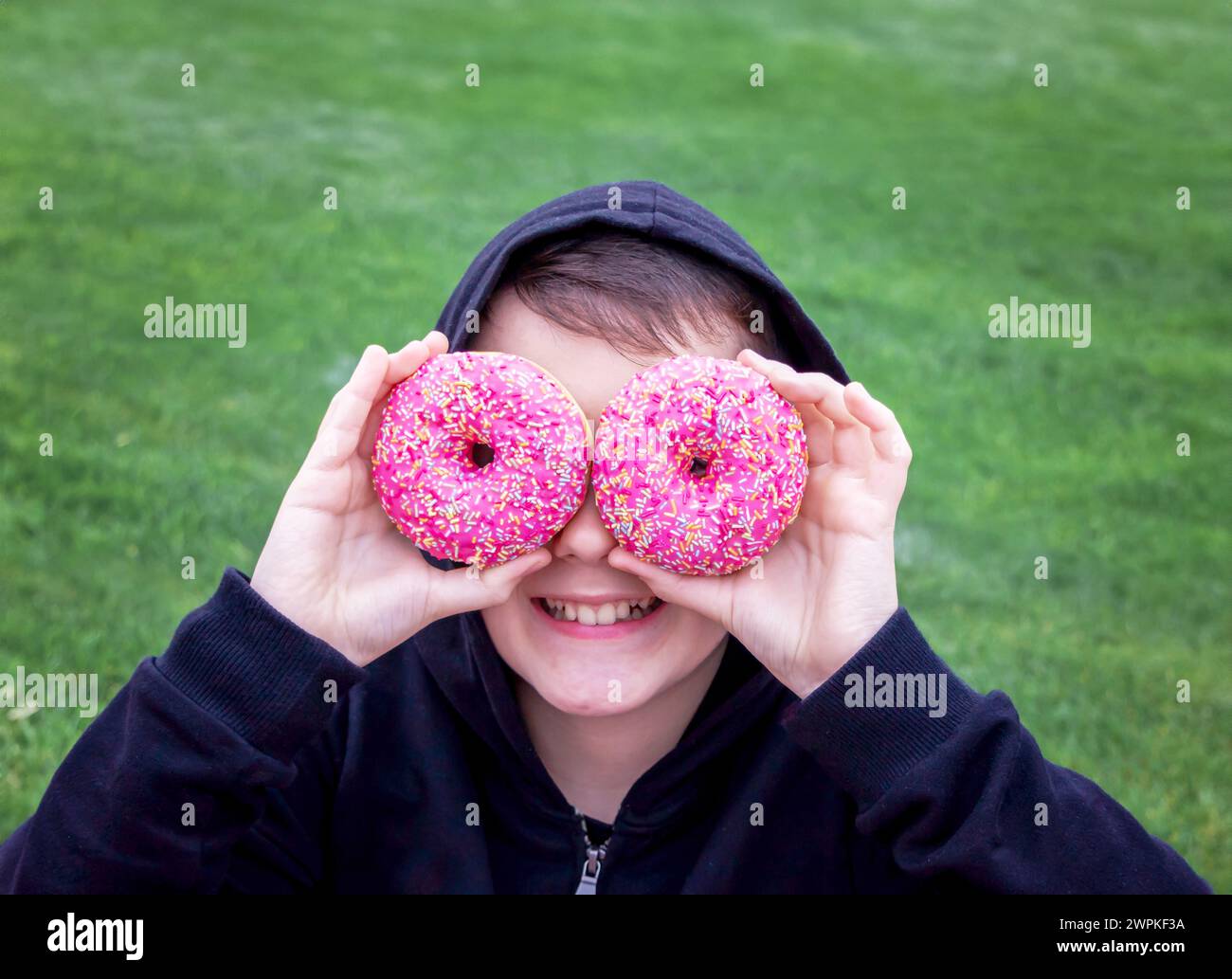 Child have fun with donuts Stock Photo - Alamy