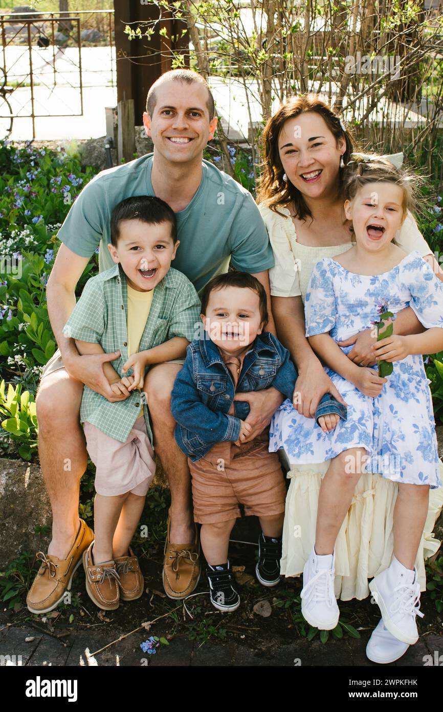 Family with multiple kids smile and laugh together in spring Stock ...