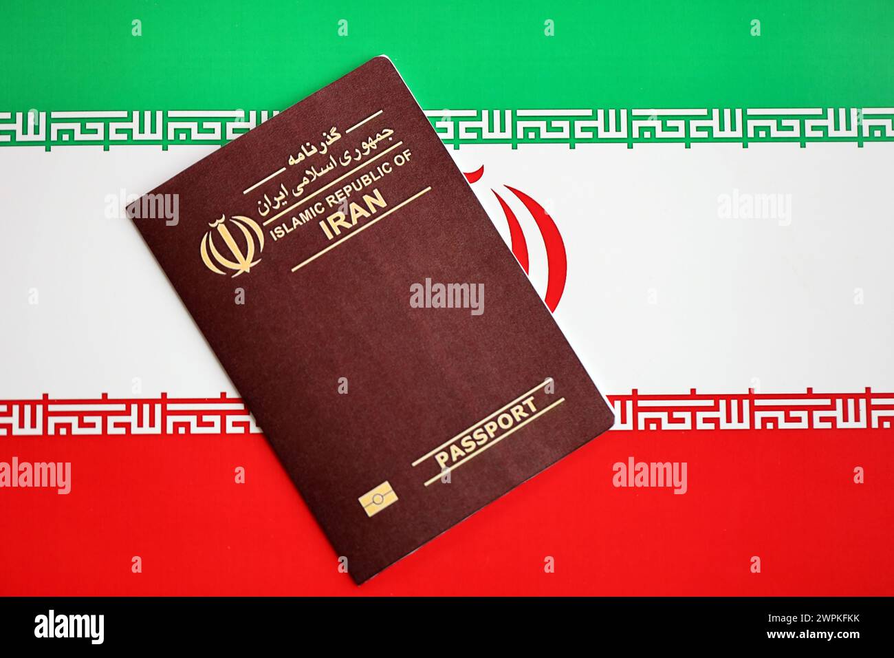 Red Islamic Republic of Iran passport on national flag background close ...