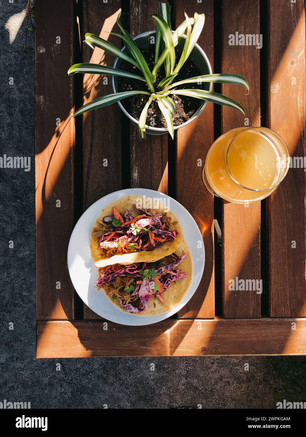 pulled pork cabbage tacos in the backyard patio Stock Photo - Alamy
