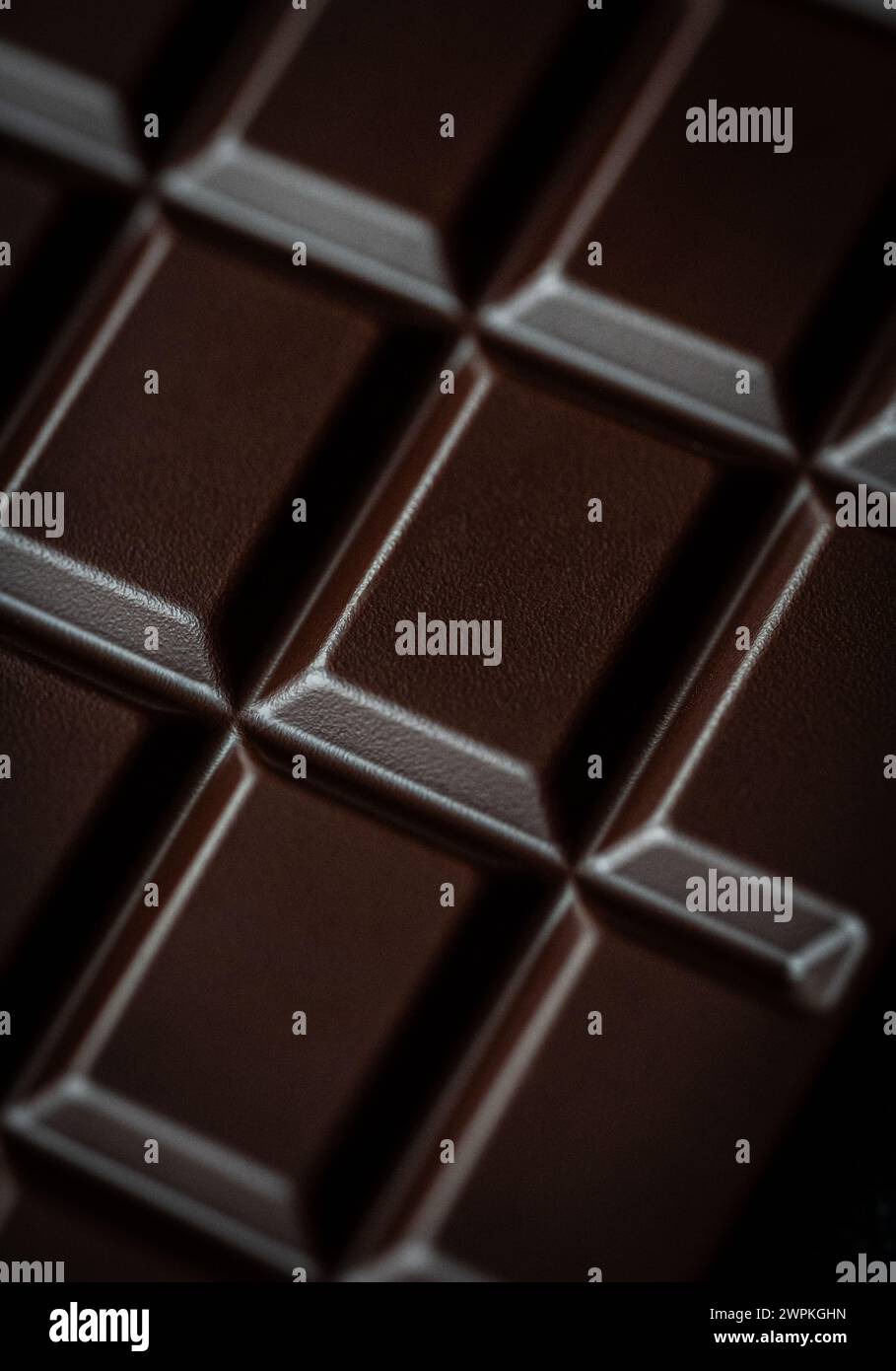 Close up macro of squares of a bar of dark chocolate from above Stock ...