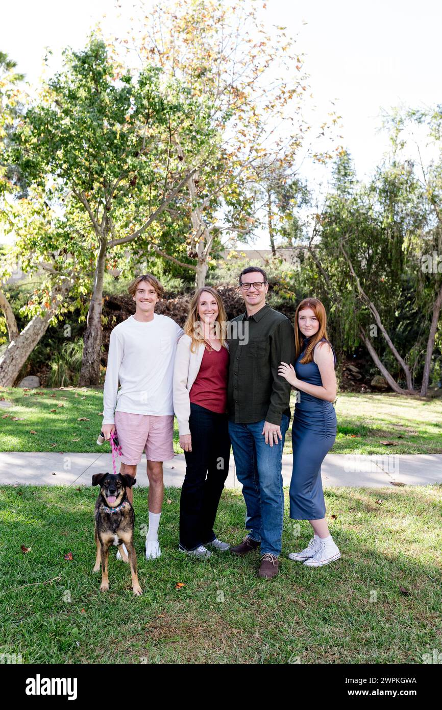 Family of four with mom dad sister brother and dog hi-res stock ...