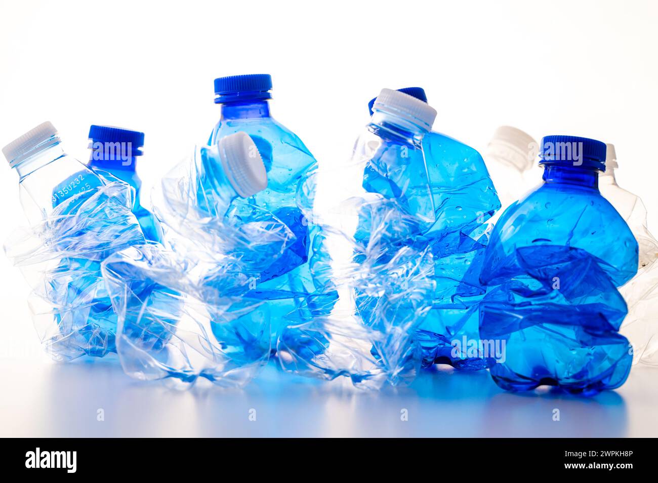 Plastic bottles, blue and transparent, crushed. Waste and plastic ...