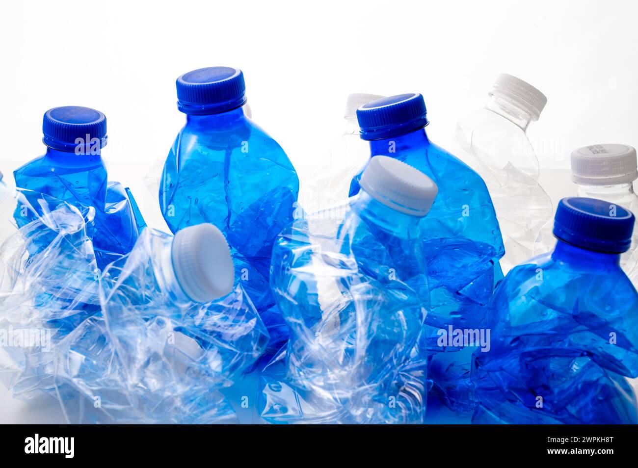 Plastic bottles, blue and transparent, crushed. Waste and plastic ...