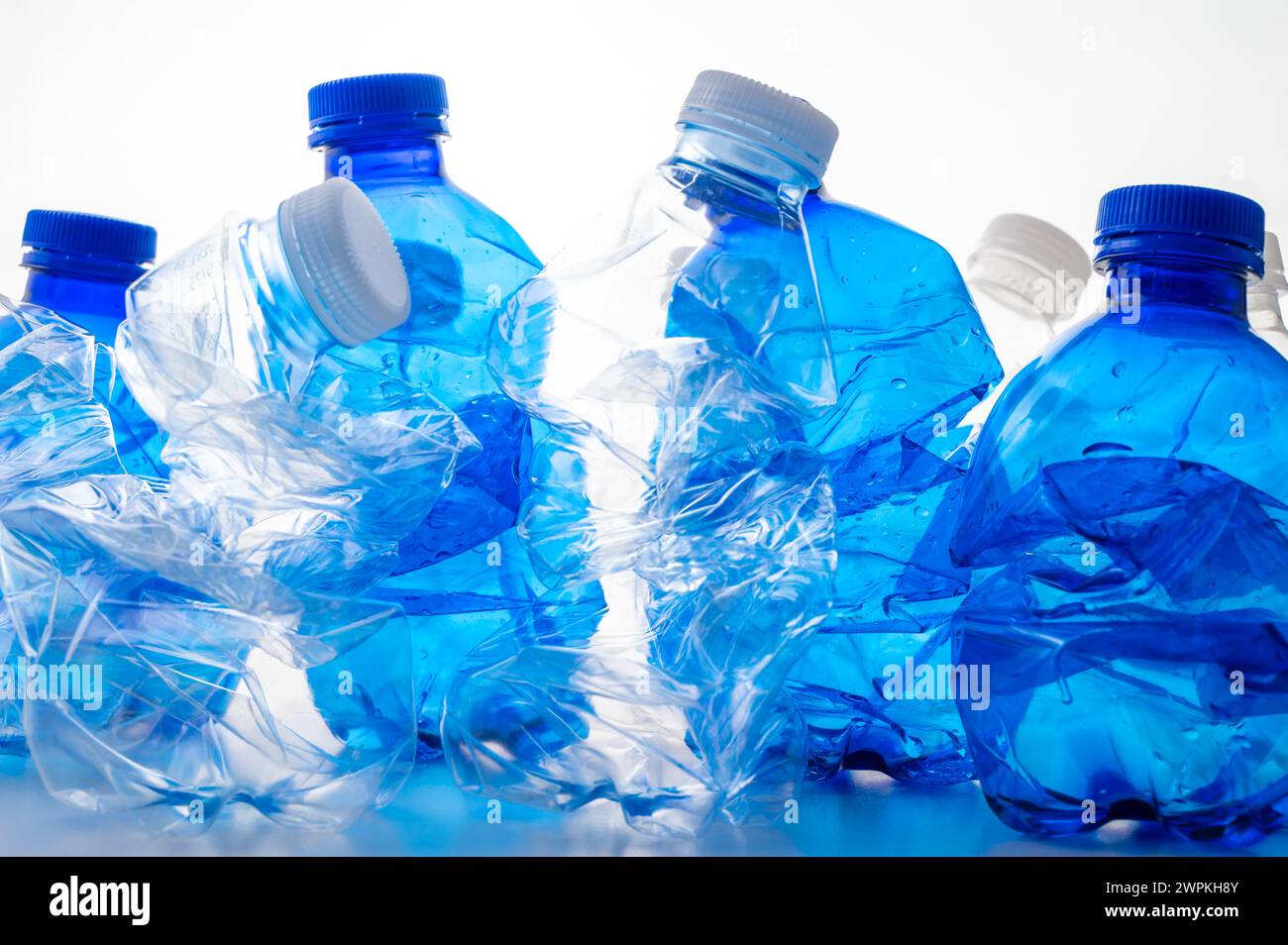 Plastic bottles, blue and transparent, crushed. Waste and plastic ...