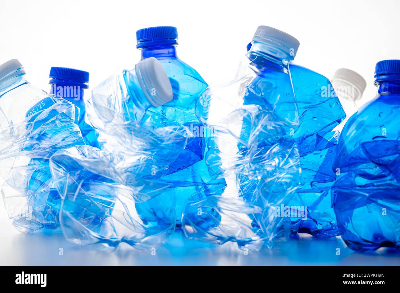 Plastic bottles, blue and transparent, crushed. Waste and plastic ...
