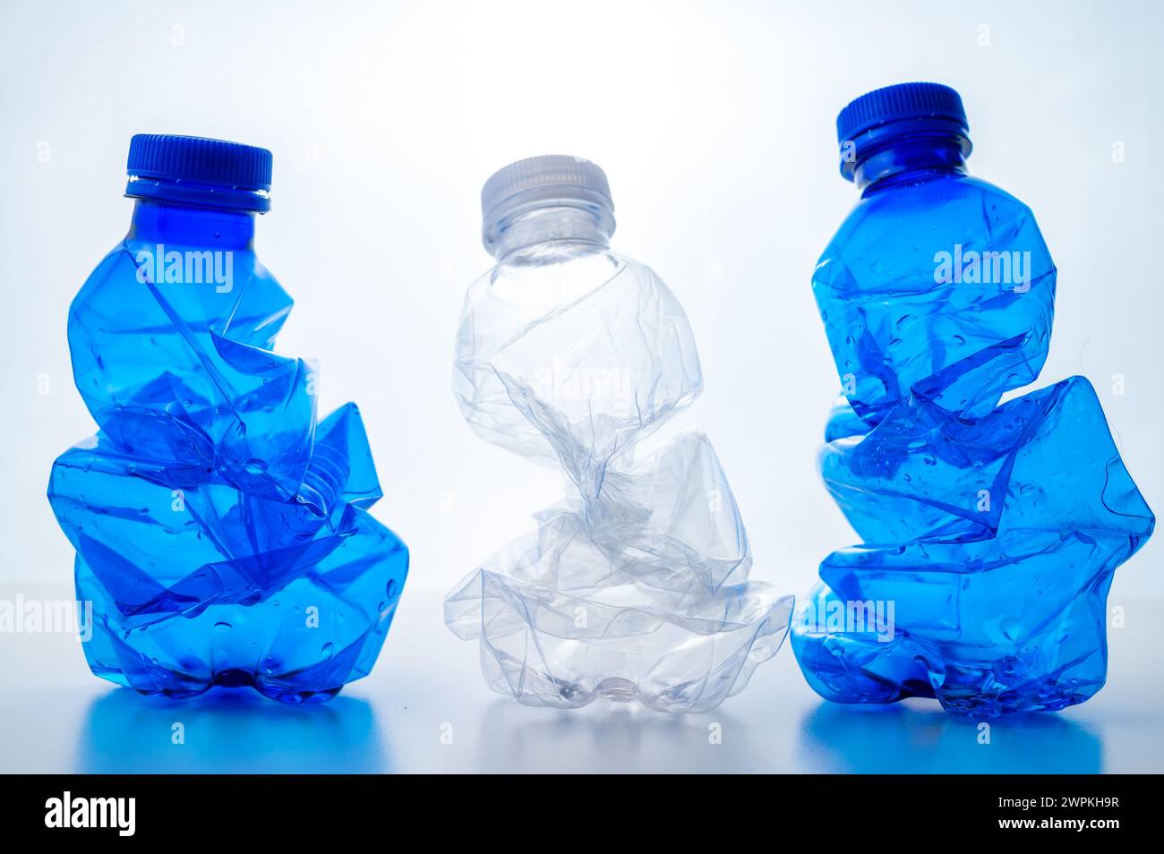 Plastic bottles, blue and transparent, crushed. Waste and plastic ...