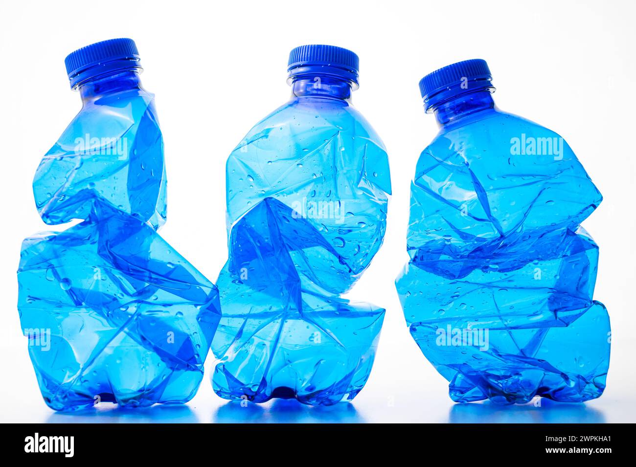 Plastic bottles, blue and transparent, crushed. Waste and plastic ...