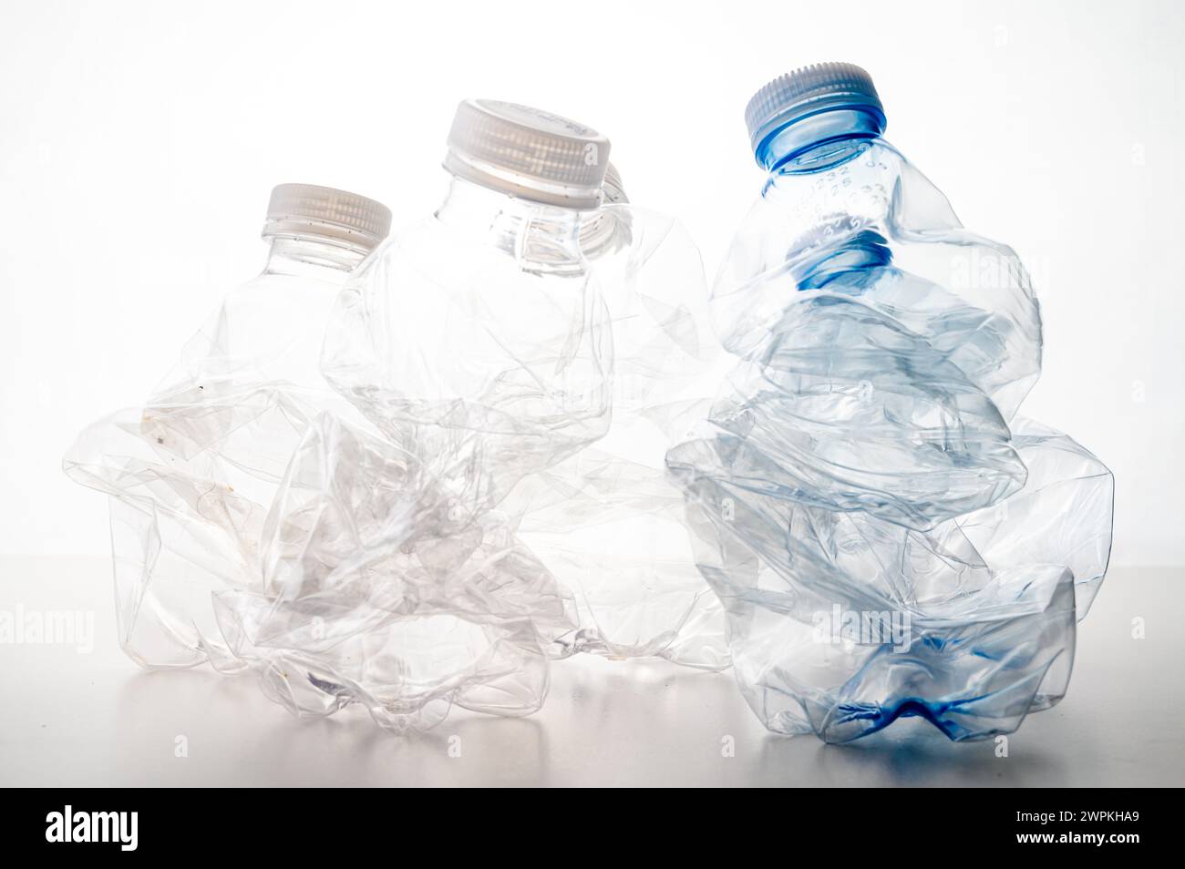 Plastic bottles, blue and transparent, crushed. Waste and plastic ...