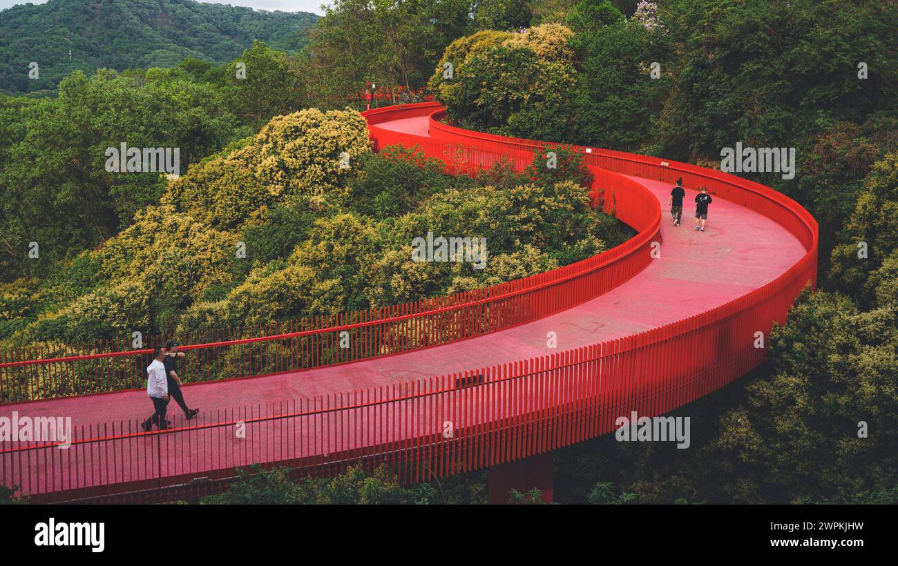 A bright red walkway over Hongqiao Park in Guangming District, Shenzhen ...