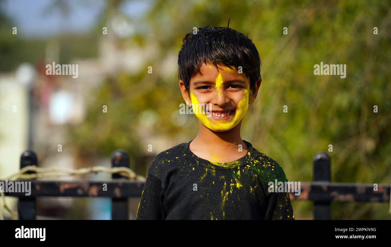 Young cute cheerful little kids with applied holi colors powder showing ...