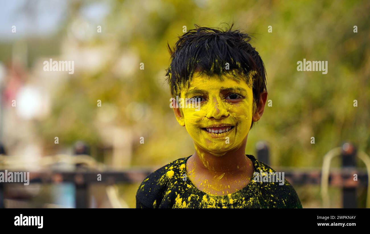 Young cute cheerful little kids with applied holi colors powder showing ...