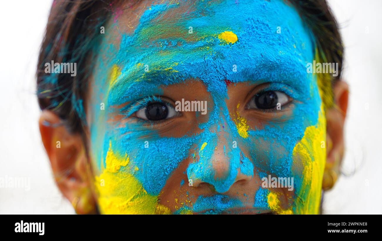 Young cute cheerful little girl kid with applied holi colors powder ...
