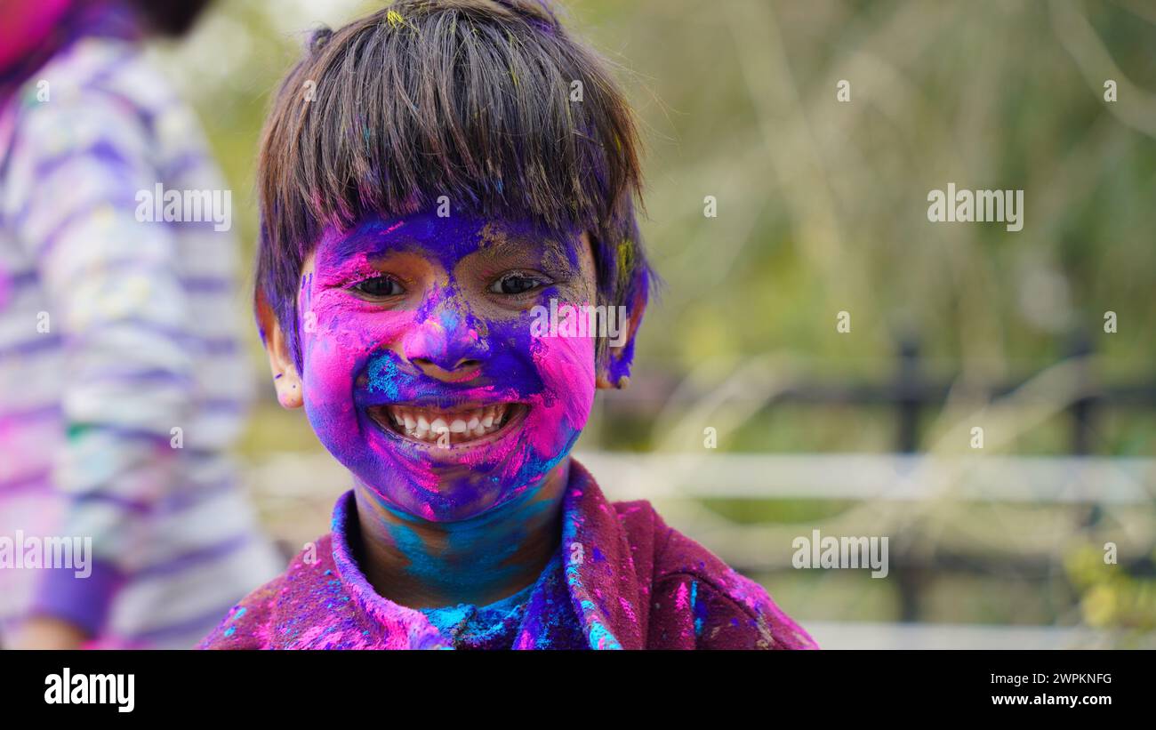 Happy Indian friends or kids celebrating the Hindu festival of Holi by ...