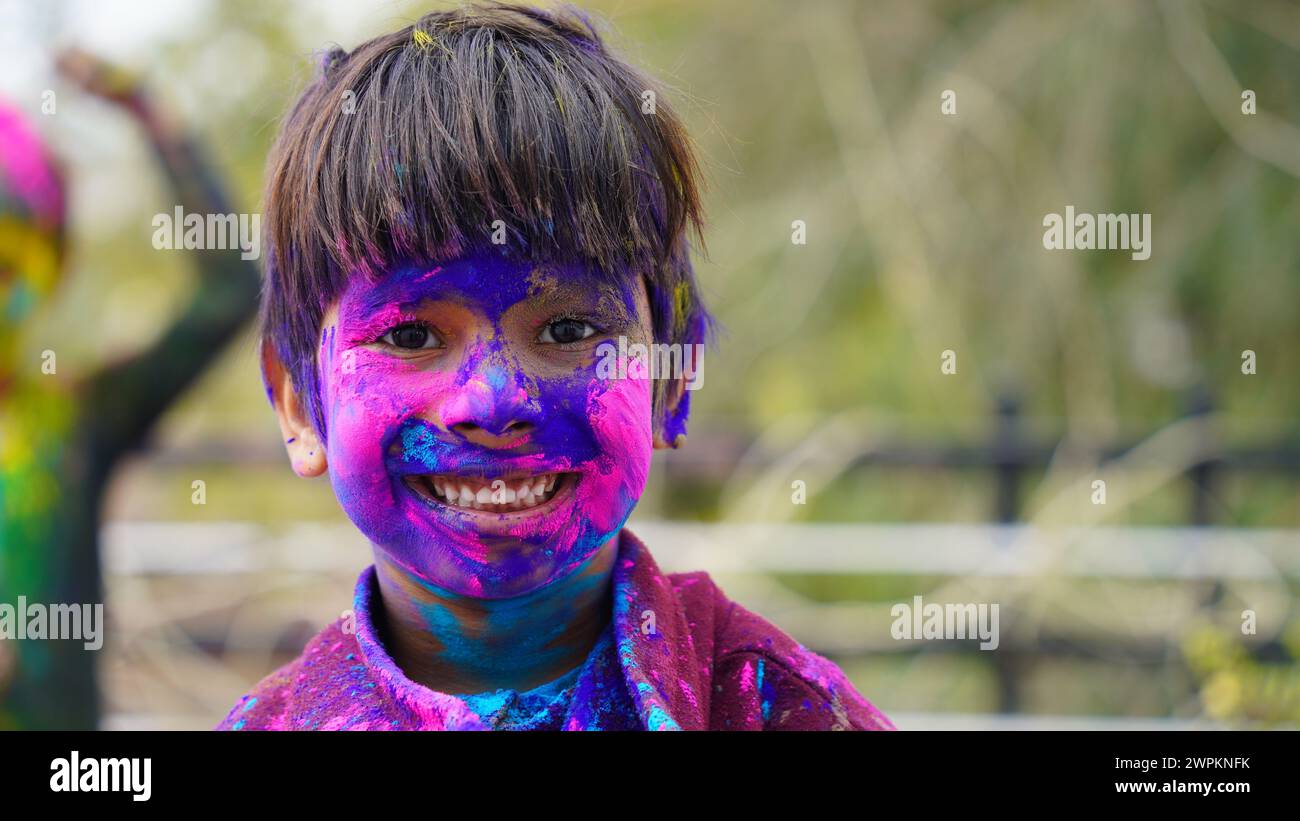 Happy Indian friends or kids celebrating the Hindu festival of Holi by ...