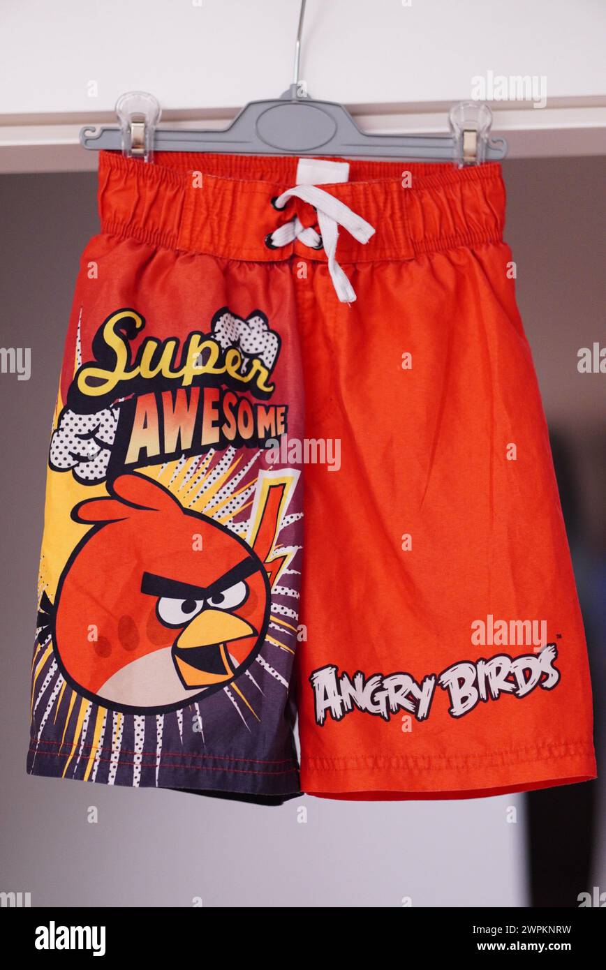 The red Angry Birds-designed shorts hanging on a door Stock Photo - Alamy