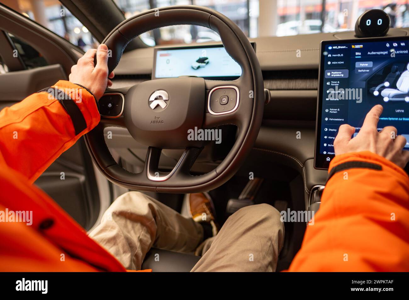 close-up male driver's hand manipulates on electronic display, steering ...