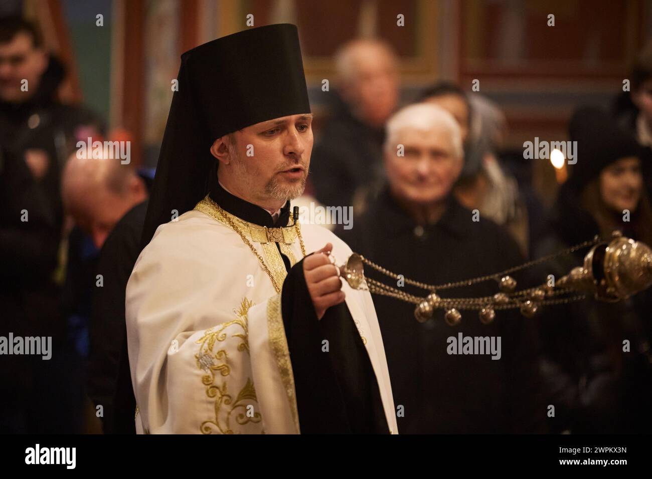 Ukrainian orthodox christian priest praying at a memorial service for ...