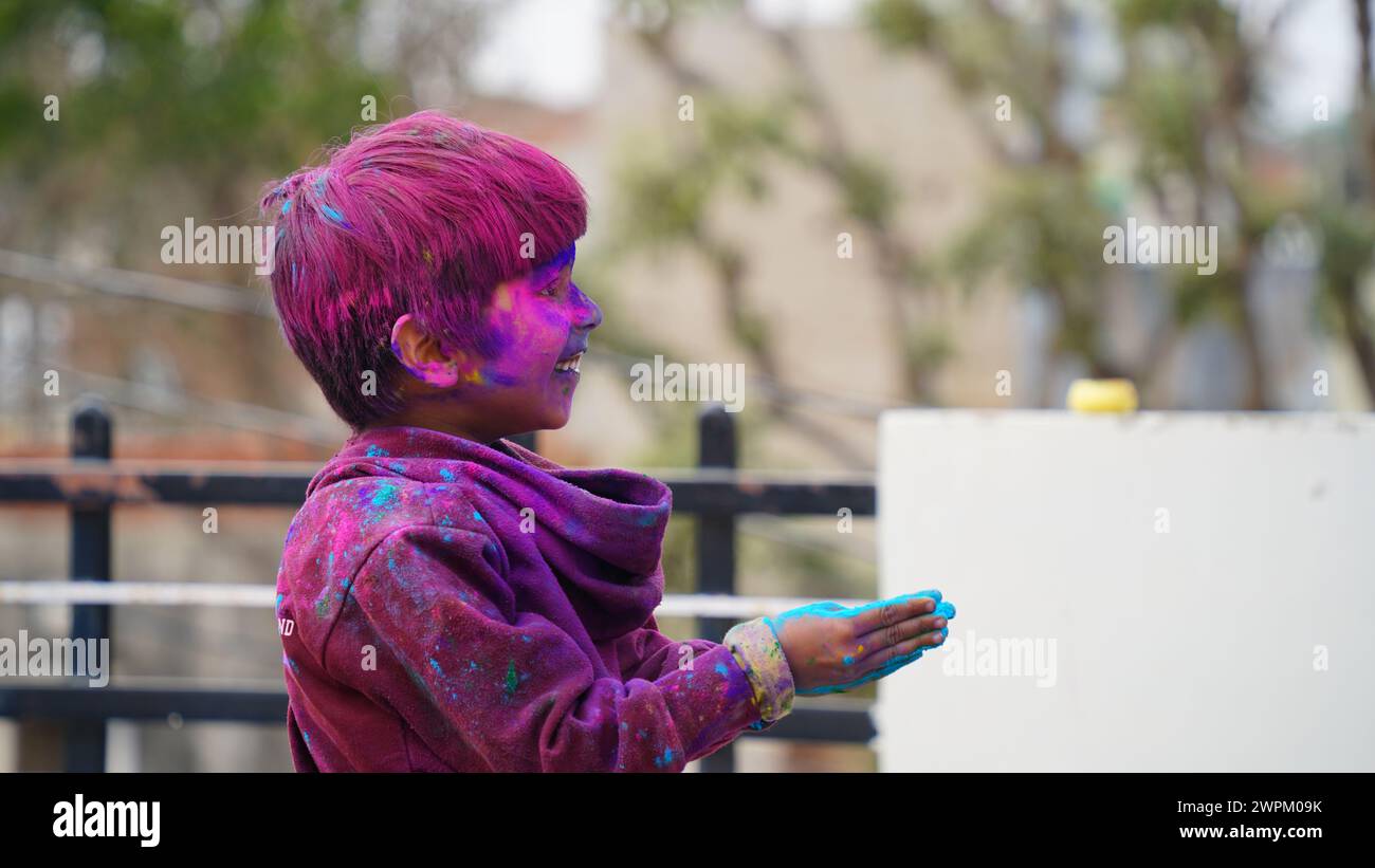 Children covered in colored powder during the festival of Holi. Happy ...